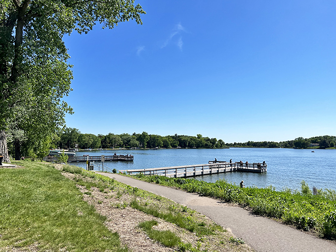 Summer serenity at Crooked Lake Park. A wooden pier invites you to dip your toes or cast a line into tranquil waters.