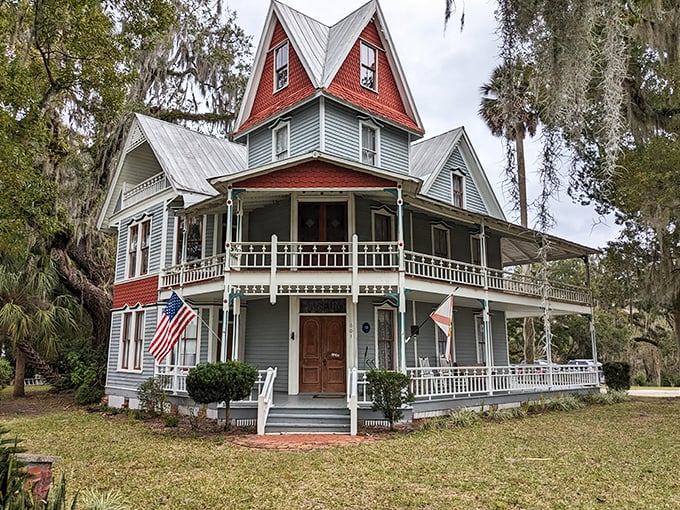 Wrap-around porch perfection! Imagine sipping sweet tea here, fanning yourself like a proper Southern belle (or beau).
