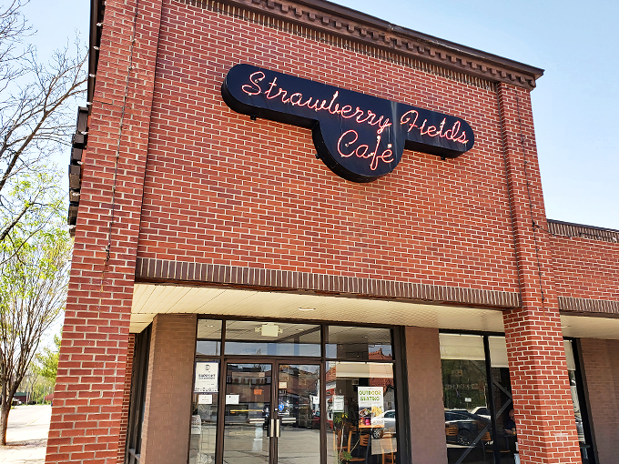 Step into this charming caf&eacute;, where the red awning winks at you like a mischievous strawberry. Prepare for a berry good time!