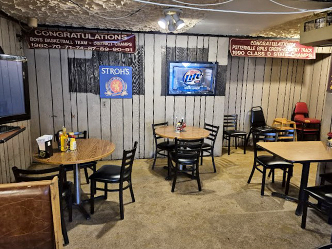 Step into a time capsule of local pride. This cozy corner, adorned with vintage beer signs and sports accolades, feels like your favorite uncle's man cave.