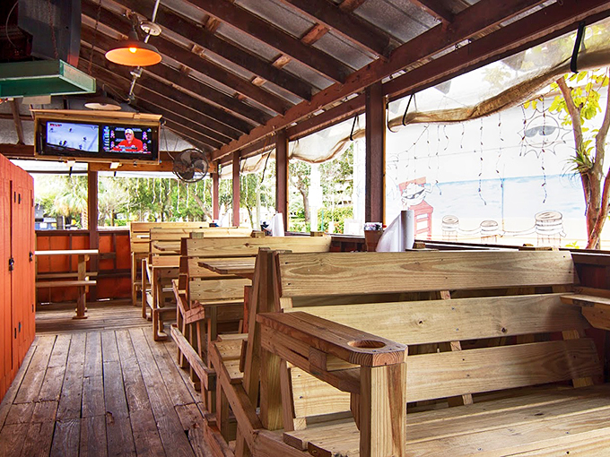 Rustic charm meets beachside bliss. This dining area feels like your cool uncle's backyard patio, complete with a TV for catching the game.