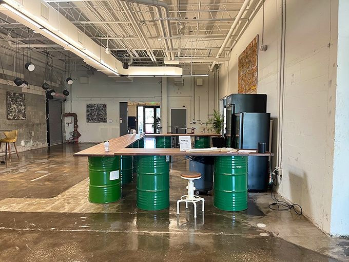 Industrial chic meets artistic flair. Who knew oil drums could be the perfect pedestal for creativity? It's like a hipster's dream garage sale!