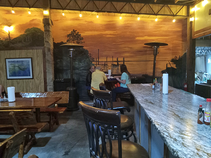 Step into a coastal paradise! This cozy interior, with its sunset mural, is like a warm hug from the ocean itself.