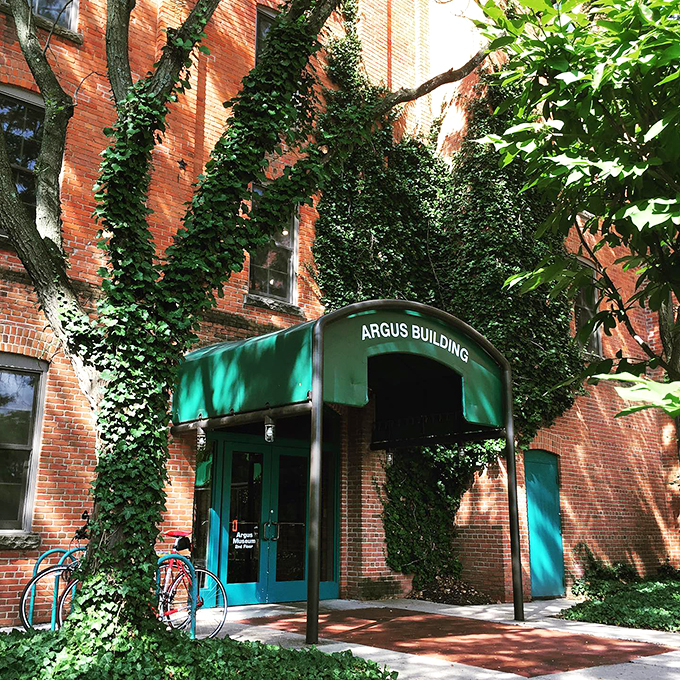 Green awning, red brick, and a dash of mystery. This entrance is like a portal to the past, where every click and whir tells a story.