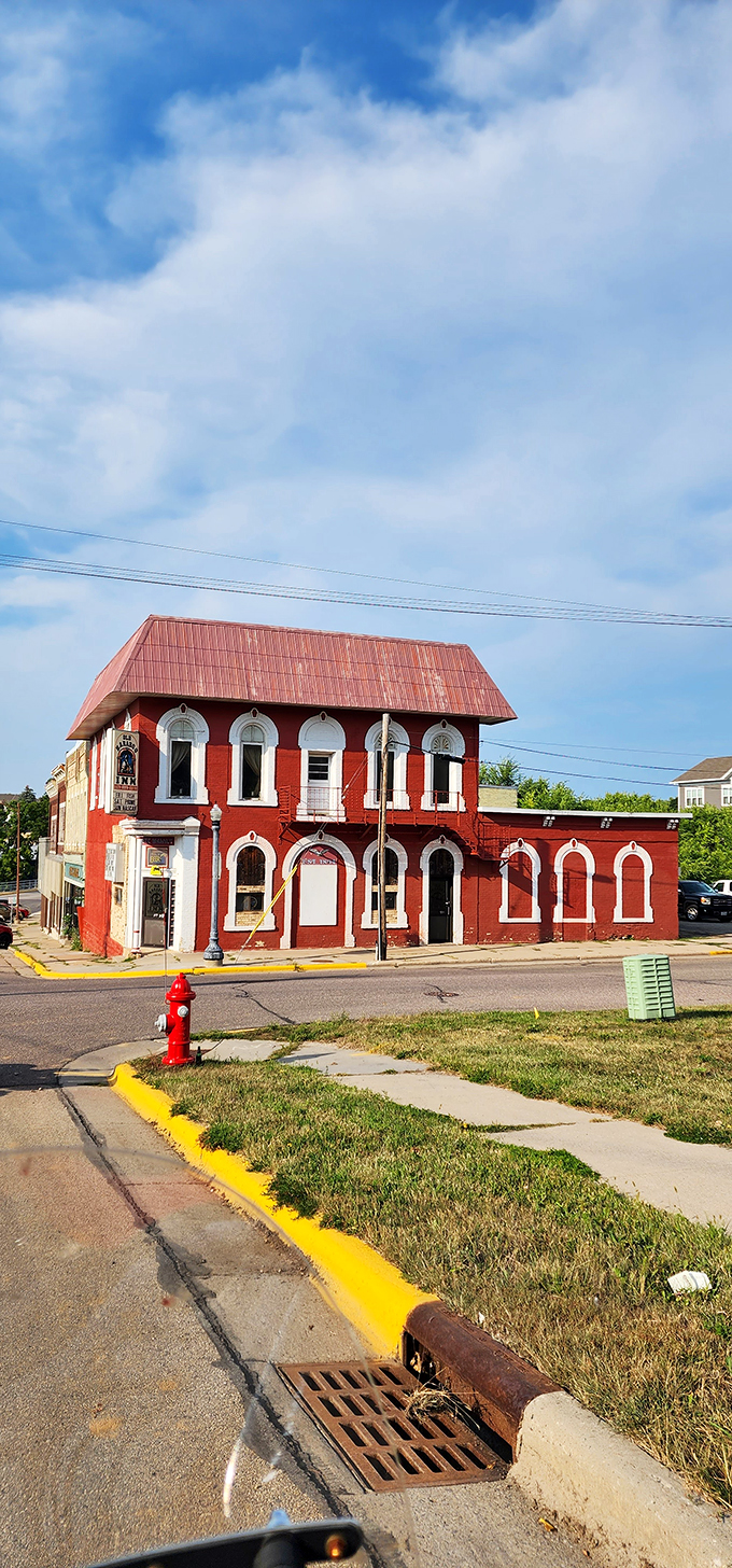 With its vibrant red exterior and charming arched windows, this historic building looks like it's been plucked straight from a Victorian ghost story. Goosebumps, anyone?
