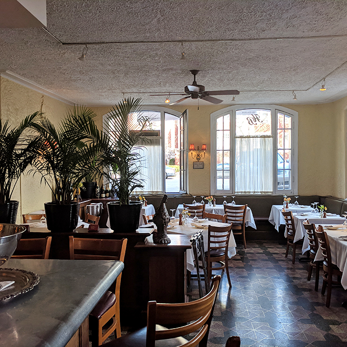 Step into a Midnight in Paris moment! Warm lighting, arched windows, and cozy tables create an atmosphere that's pure French romance. Ooh la la!