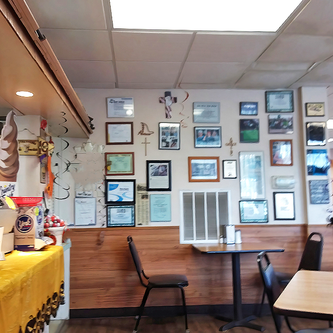 Wall of fame or hall of yum? This cozy interior showcases decades of happy customers and culinary triumphs.