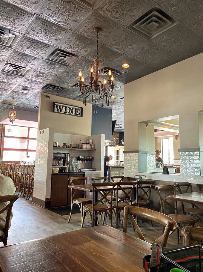 Step inside and you're transported to a rustic Italian dream. That ornate tin ceiling and chandelier? It's giving "Nonna's fancy dining room" vibes.