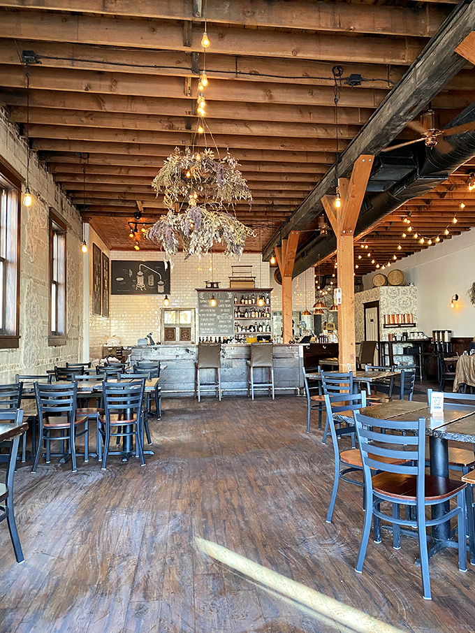 Step into a Pinterest board come to life! Exposed beams, twinkling lights, and blue chairs create a space that's cozier than your grandma's hug.