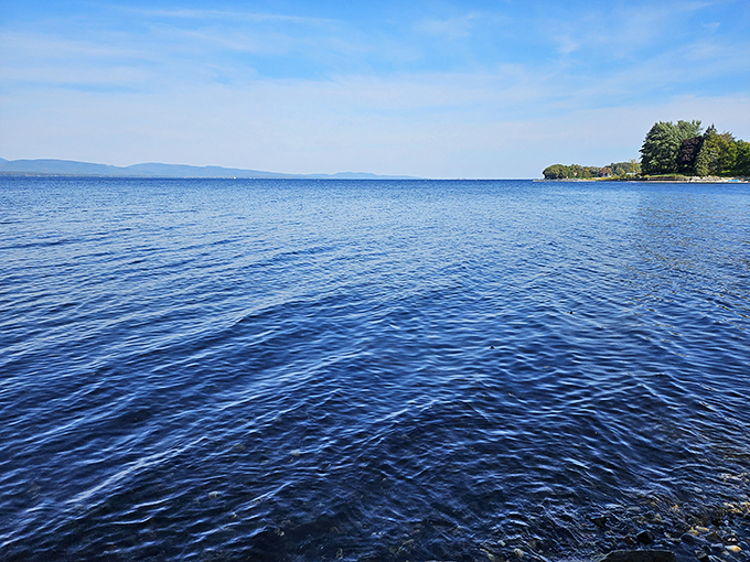 Lake Champlain's crystal-clear waters stretch to the horizon, offering a view that's pure Vermont magic.