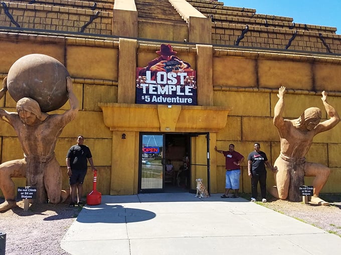 Talk about a weighty welcome! These muscular statues seem to be saying, 'Enter at your own risk... and maybe skip arm day tomorrow.