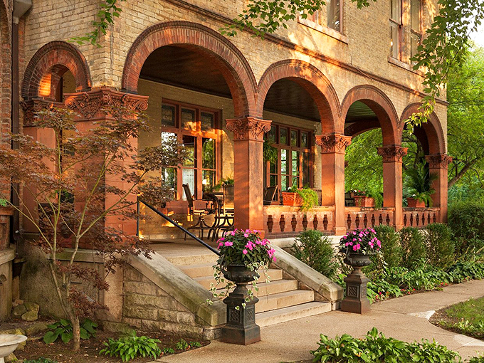 Arches that could make a Roman emperor jealous! The porch beckons with its warm glow, promising cozy conversations and maybe a spot of afternoon tea.