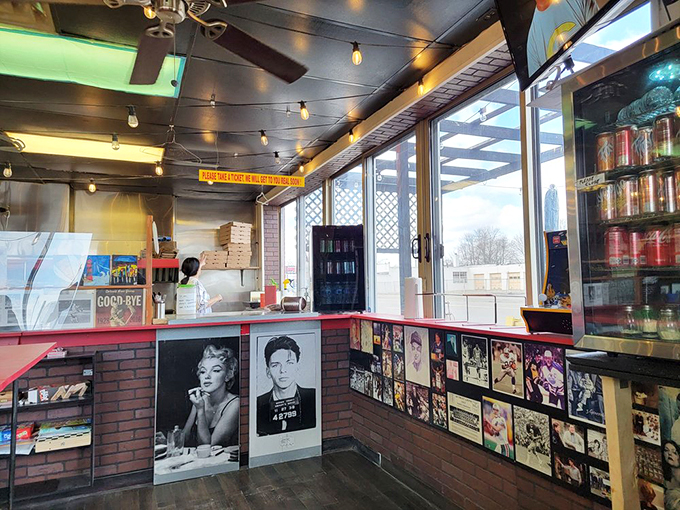 Step into pizza paradise! This cozy interior, adorned with vintage photos and string lights, feels like a warm hug from your favorite Italian nonna.