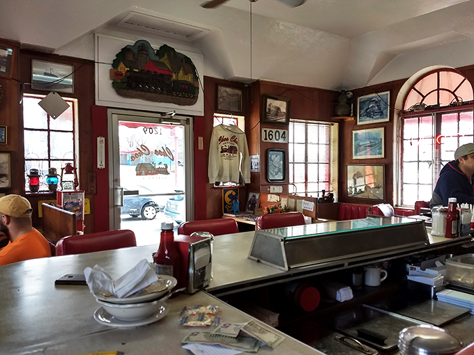 Step inside and you're transported to a bygone era. The walls whisper tales of rail adventures, while the counter beckons with promises of comfort food delights.