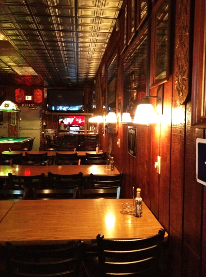 Step into a time capsule of comfort! The Keyhole's interior is a warm embrace of wood paneling and soft lighting, promising good times and even better eats.