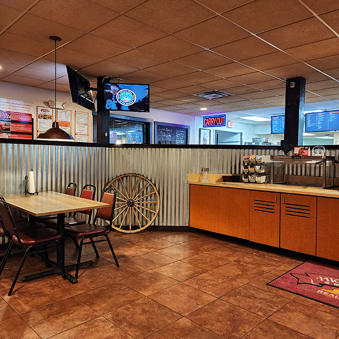 Step inside and feast your eyes! The rustic charm of corrugated metal meets modern comfort, creating an atmosphere that's as inviting as grandma's kitchen &ndash; if grandma were a pit master.