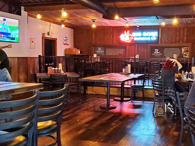 Step inside and let the aroma guide you. This cozy interior is where barbecue dreams come true, illuminated by the warm glow of Edison bulbs.