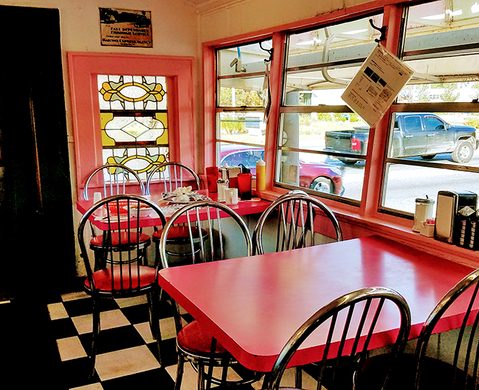Checkerboard floors and chrome dreams: This isn't just a diner, it's a time machine with a side of stained glass.