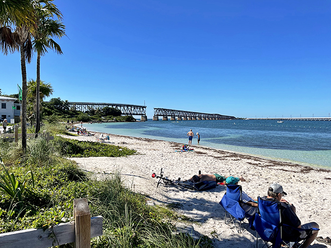 Old meets new: A historic bridge frames nature's masterpiece of turquoise waters and white sand.