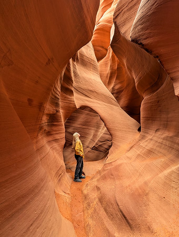 Light show extraordinaire: Sunbeams dance through twisting sandstone, creating a natural cathedral of color and shadow.