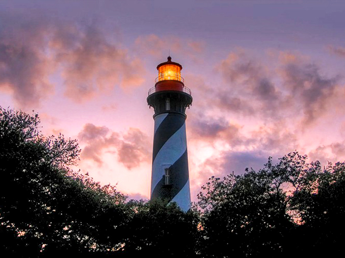 Twilight's embrace: The St. Augustine Lighthouse stands sentinel, its spiral stripes a beacon of both safety and spookiness.