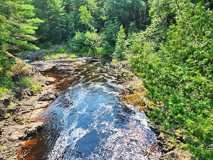 The way this waterfall crashes into that dark pool makes you want to sit on those rocks and forget about everything else.