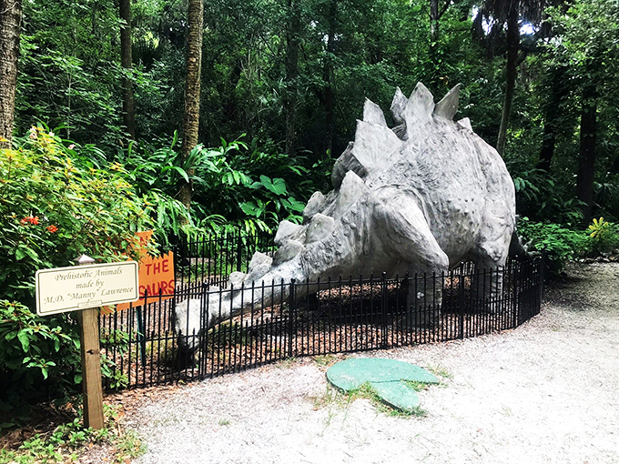 Nature's costume party! Concrete dinosaurs and crumbling sugar mill ruins create a delightfully bizarre time-travel experience in lush Florida greenery.