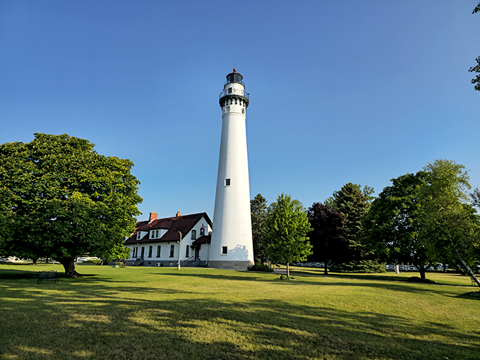 Honey, I shrunk the lighthouse! From afar, it's a picturesque pit stop on your lakeside adventure.