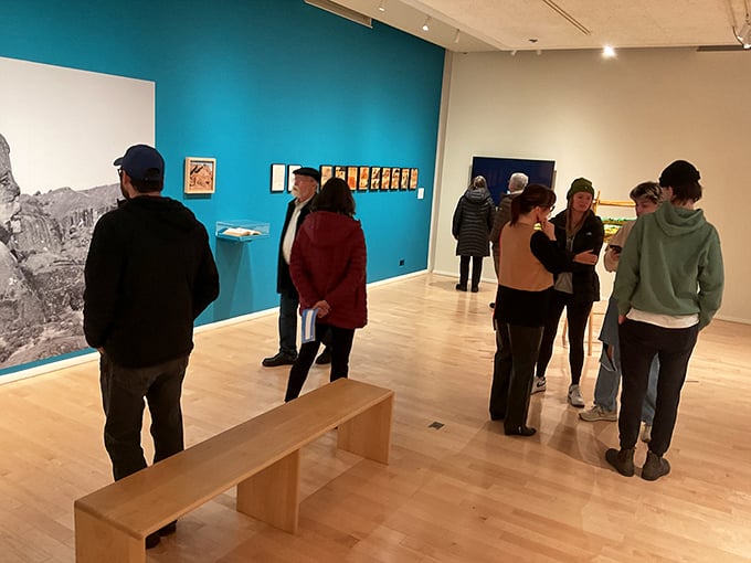 Art appreciation in action! These gallery-goers are drinking in the culture like it's a fine Vermont craft beer. Who says learning can't be fun?