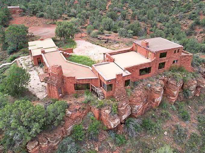 Imagine waking up to this view every day. The House of Apache Fire perches like a desert eagle's nest, surveying its crimson kingdom.