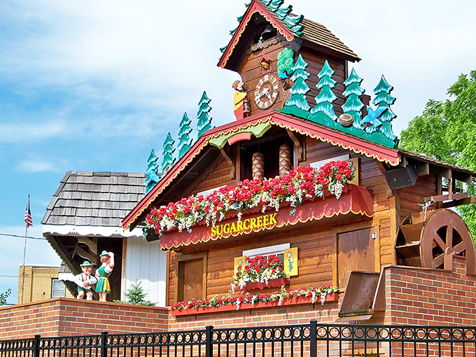 It's like a dollhouse for giants! This close-up reveals the clock's intricate details, from tiny trees to flower-box eye candy.