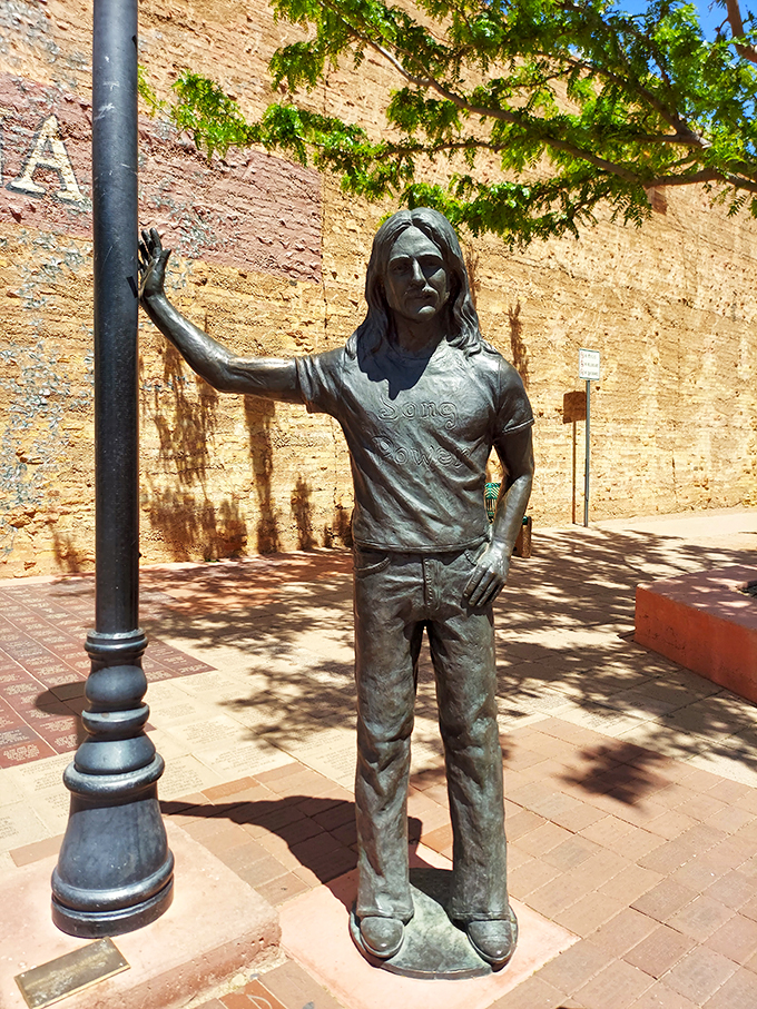 "Take it easy," the statue seems to say. This bronze tribute to the Eagles' hit stands tall, inviting passersby to join in a timeless musical moment.