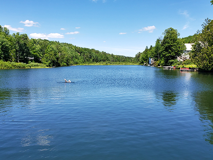 A summer swimmer dots the crystal-clear waters of Sunset Lake, making the most of Vermont's liquid playground.