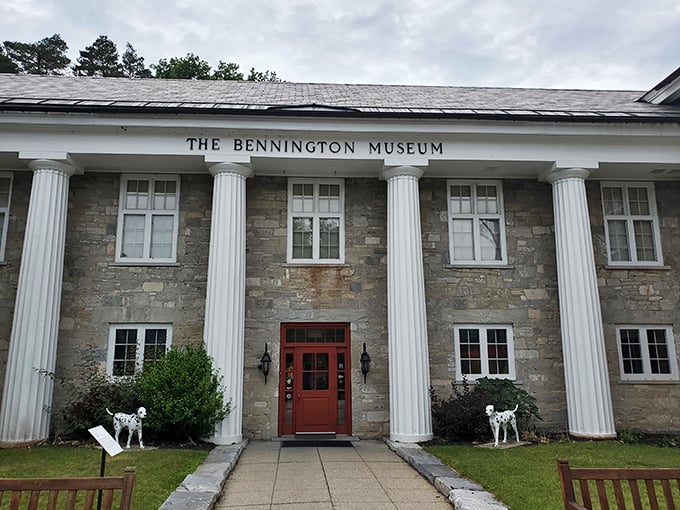 History's grand entrance! The Bennington Museum welcomes visitors with classic columns and canine sentinels standing guard.
