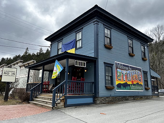 Blue building, golden treats! Laughing Moon Chocolates stands out like a delicious beacon in charming Stowe.