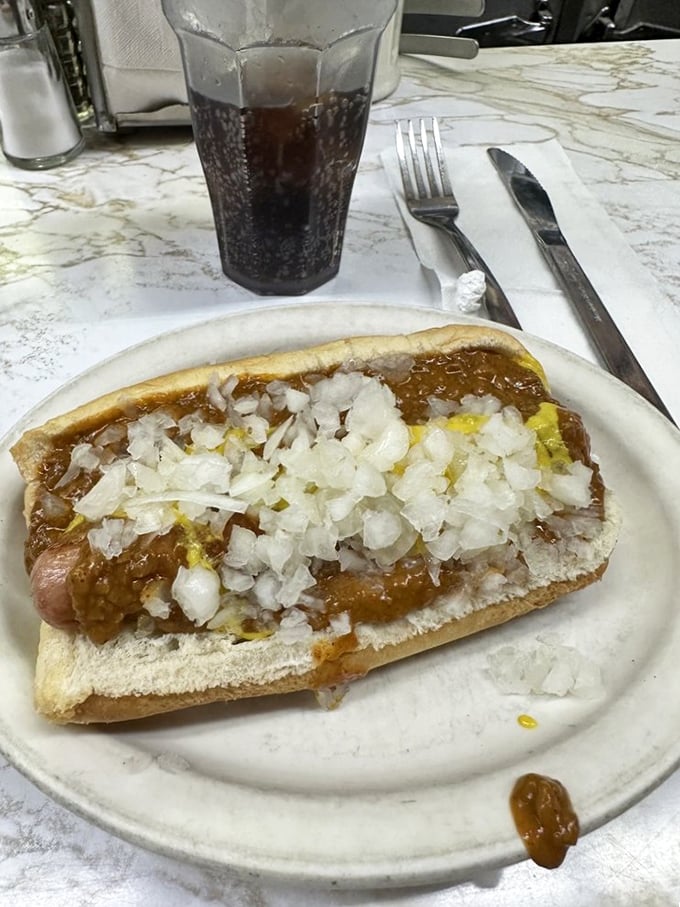 Behold, the Coney Dog in all its glory! A symphony of chili, onions, and mustard that'll make your taste buds dance.