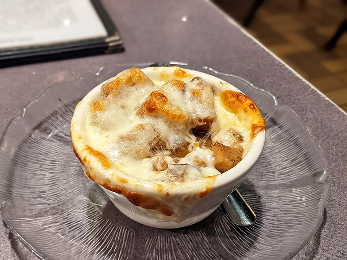 Behold, the holy grail of soups! This French onion masterpiece is bubbling with more excitement than a soap opera season finale.