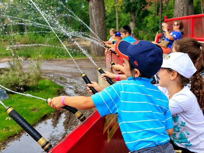 Splash zone ahead! These junior firefighters are dousing boredom faster than you can say "marshmallow roast."