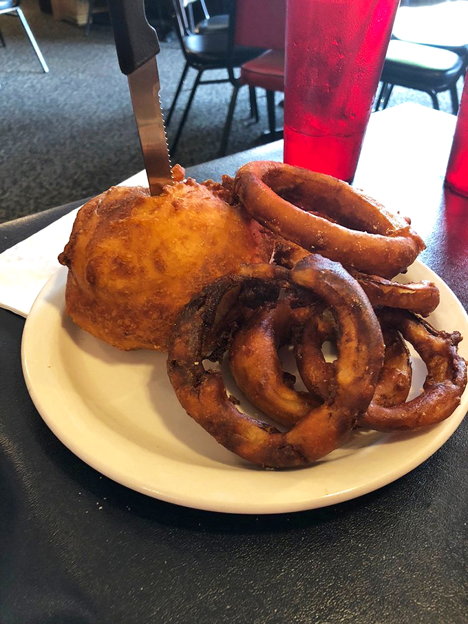Holy cow! This deep-fried burger looks like it's wearing golden armor. It's a crispy, juicy masterpiece that would make even Elvis say, "Thank you, thank you very much."