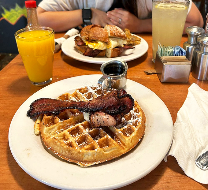 Waffle wonderland! This golden disc, crowned with bacon fit for royalty, is what breakfast dreams are made of.