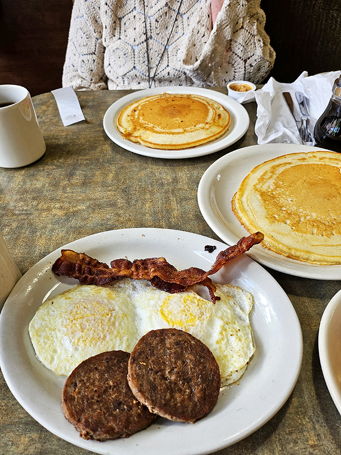 The breakfast of champions... or anyone with a hearty appetite. Golden pancakes, crispy bacon, and eggs sunny side up!