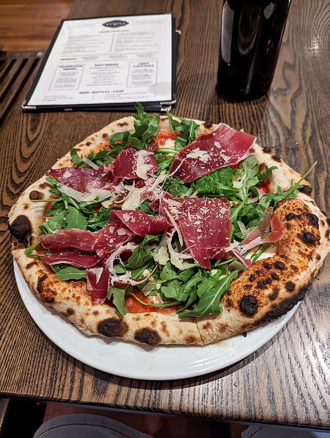 Behold, the pizza that launched a thousand food comas! This Neapolitan beauty is dressed to impress with prosciutto, arugula, and a crust that's charred to perfection.
