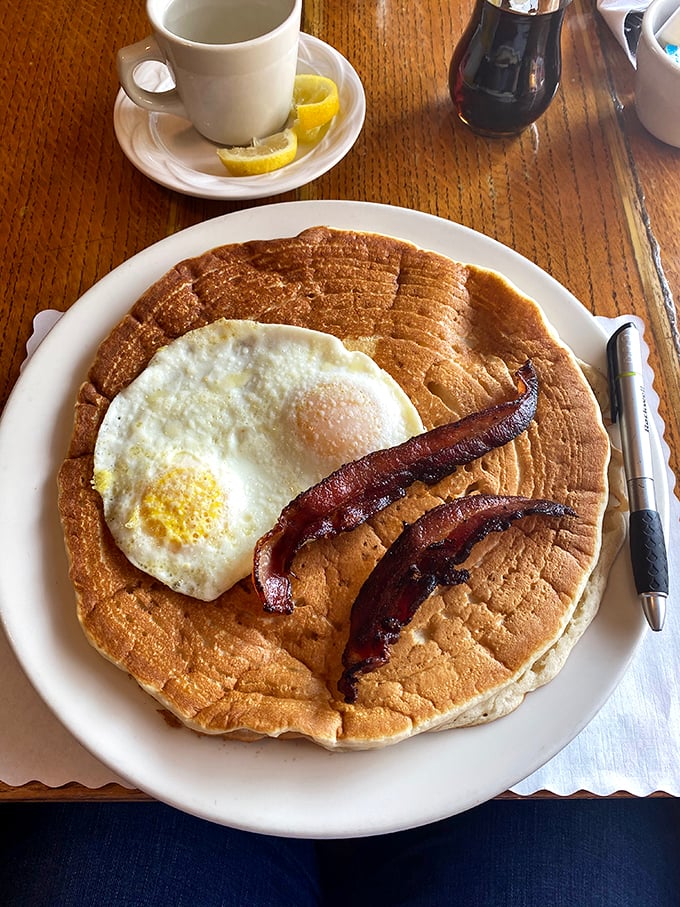 Pancakes so big, they need their own ZIP code. With a side of bacon that could make Ron Swanson weep with joy.