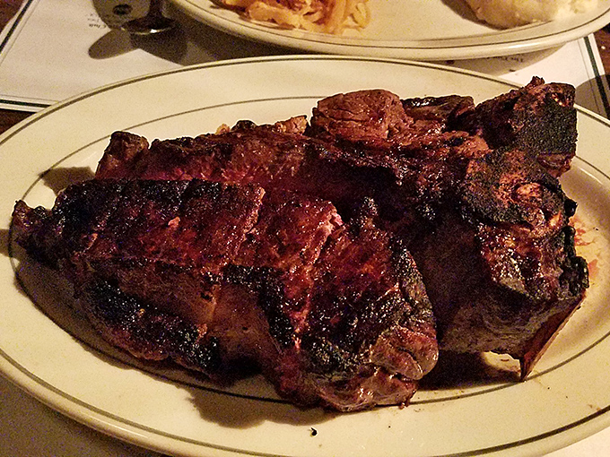 Holy cow! This Porterhouse steak is so massive, it might need its own ZIP code. Perfectly charred on the outside, pink on the inside &ndash; it's meat nirvana.
