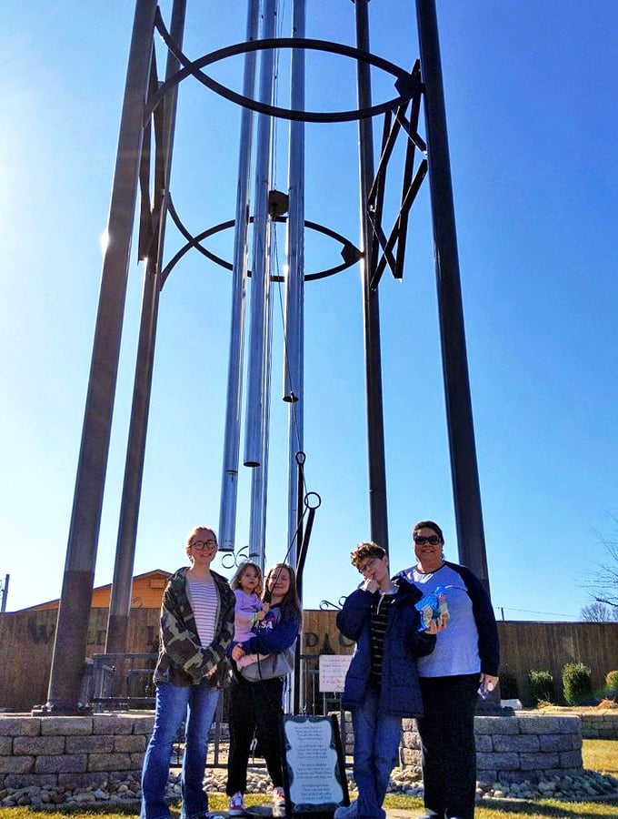 Family fun reaches new heights! These folks look like they're about to star in "Honey, I Shrunk the Tourists: Wind Chime Edition."