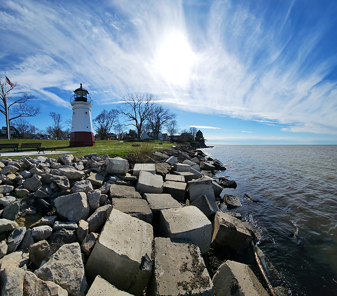 "Rocky shores, azure waters, and a lighthouse that could double as a giant chess piece. Check and mate, boring landscapes!"
