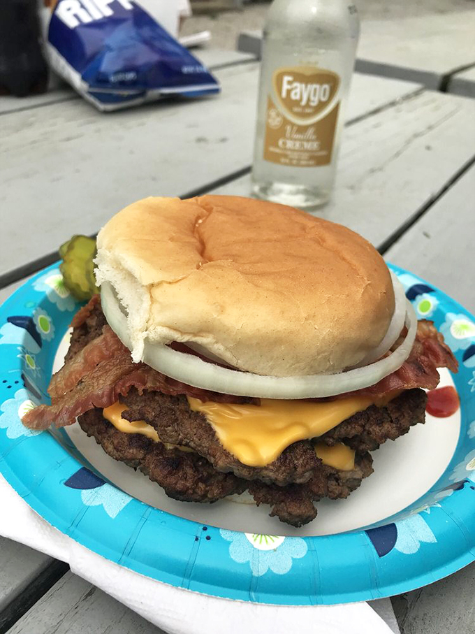 Holy cow! This burger's stacked higher than a Jenga tower. It's a meaty skyscraper that'd make even the Sears Tower jealous.