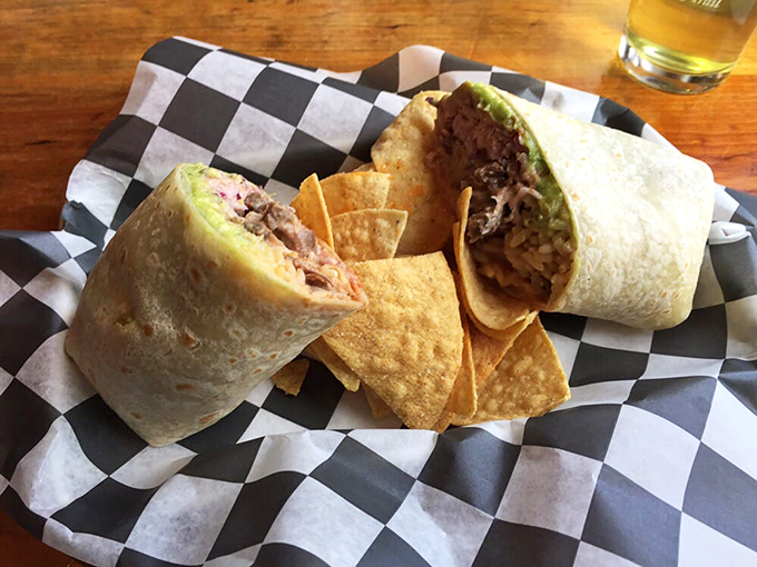 Behold, the burrito behemoth! This tortilla-wrapped wonder is like a sleeping bag for your taste buds, packed with savory goodness and a side of crispy chips.