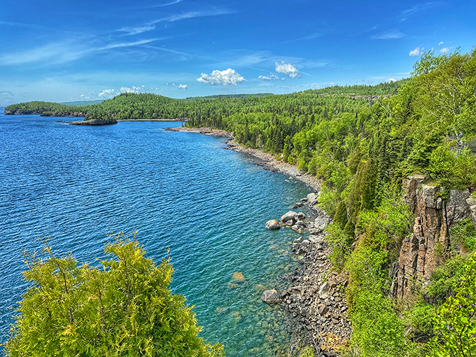 Nature's masterpiece unfolds: Lake Superior's azure waters meet forest green, creating a vista that'd make Bob Ross reach for his paintbrush.