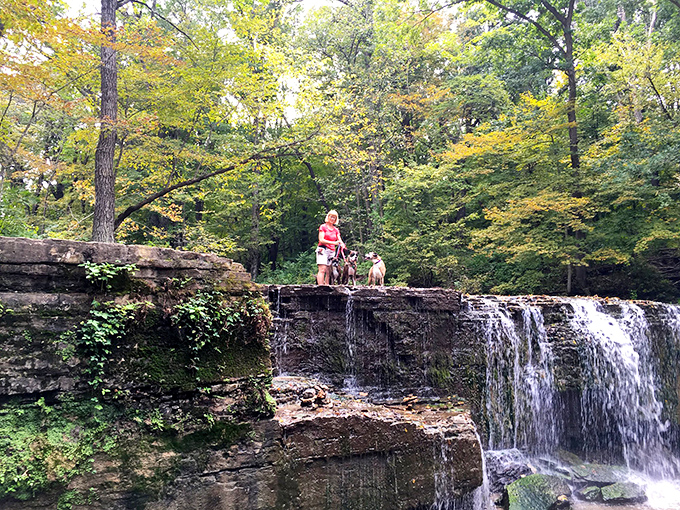 Waterfall selfie central! These intrepid explorers are living their best "Indiana Jones meets Instagram influencer" lives atop Hidden Falls.